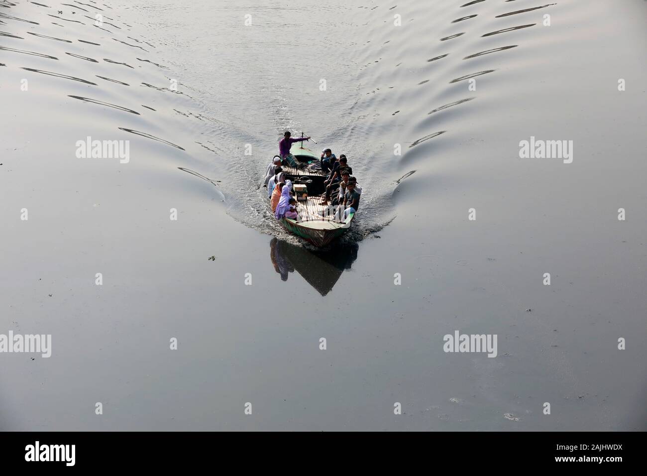Dhaka, Bangladesh - January 01, 2020: A boat moves over the river balu ...