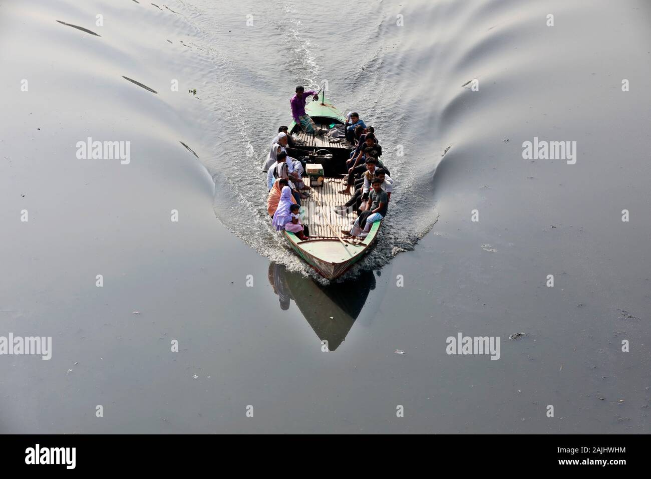 Dhaka, Bangladesh - January 01, 2020: A boat moves over the river balu ...