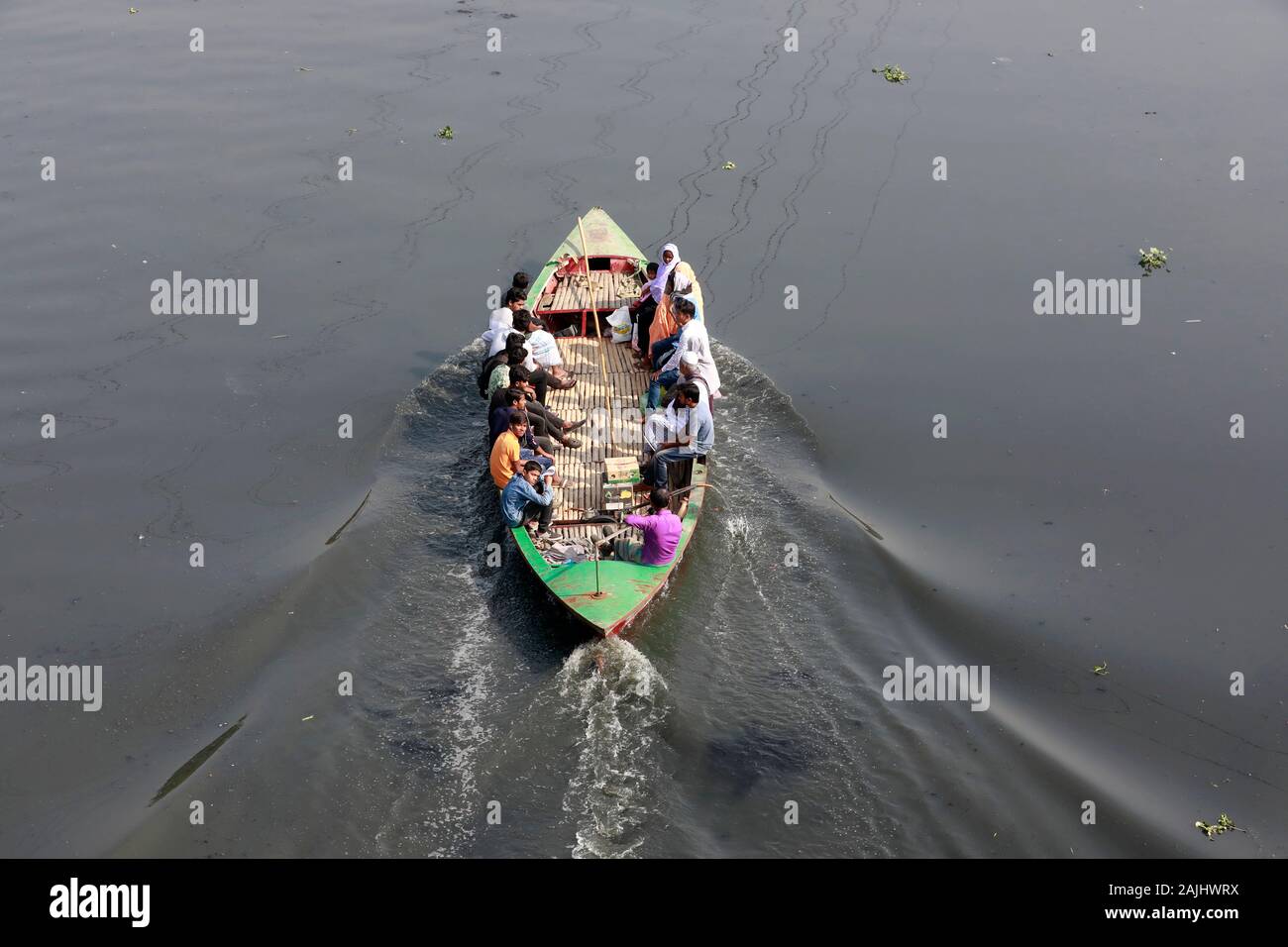 Dhaka, Bangladesh - January 01, 2020: A boat moves over the river balu ...