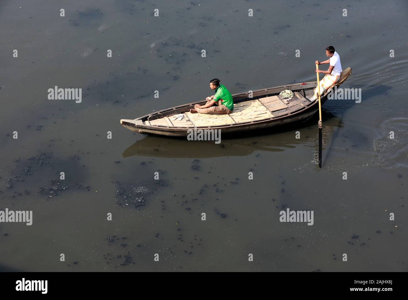 Dhaka, Bangladesh - January 01, 2020: A boat moves over the river balu ...