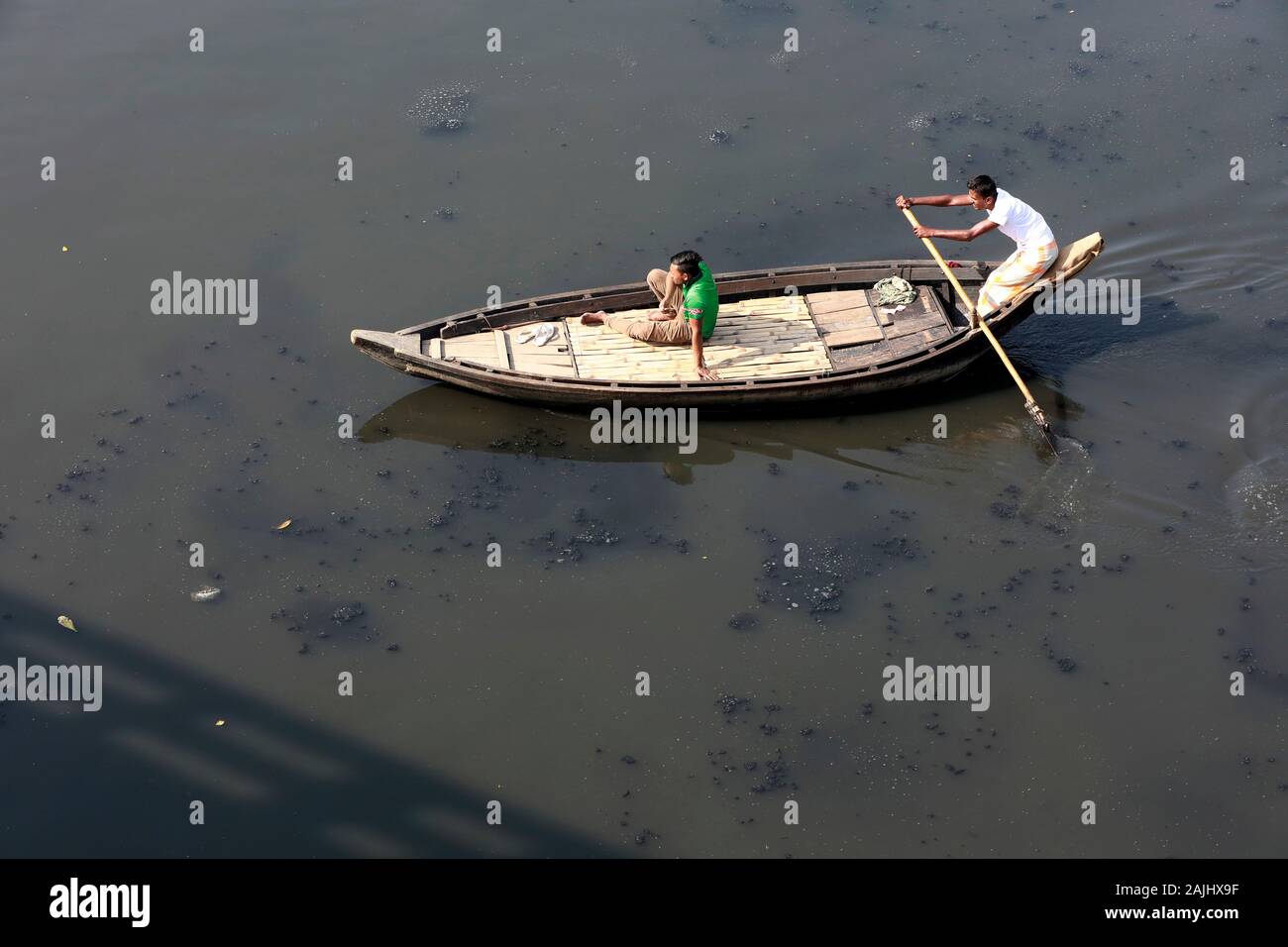 Dhaka, Bangladesh - January 01, 2020: A boat moves over the river balu ...