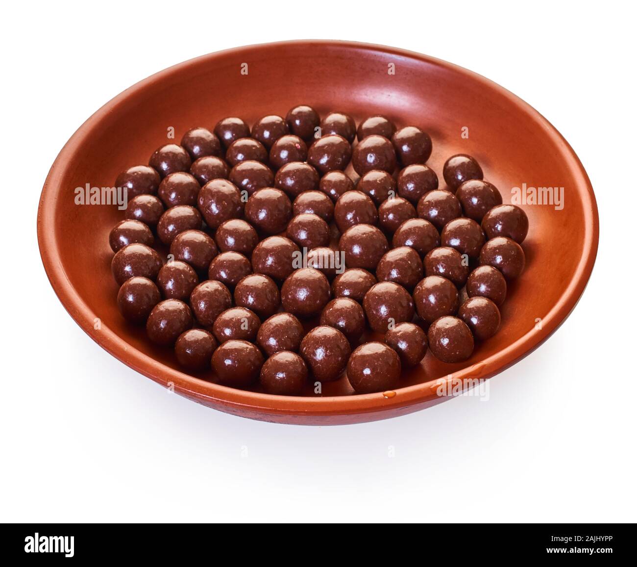 round chocolate candies in a plate on white isolated background Stock ...