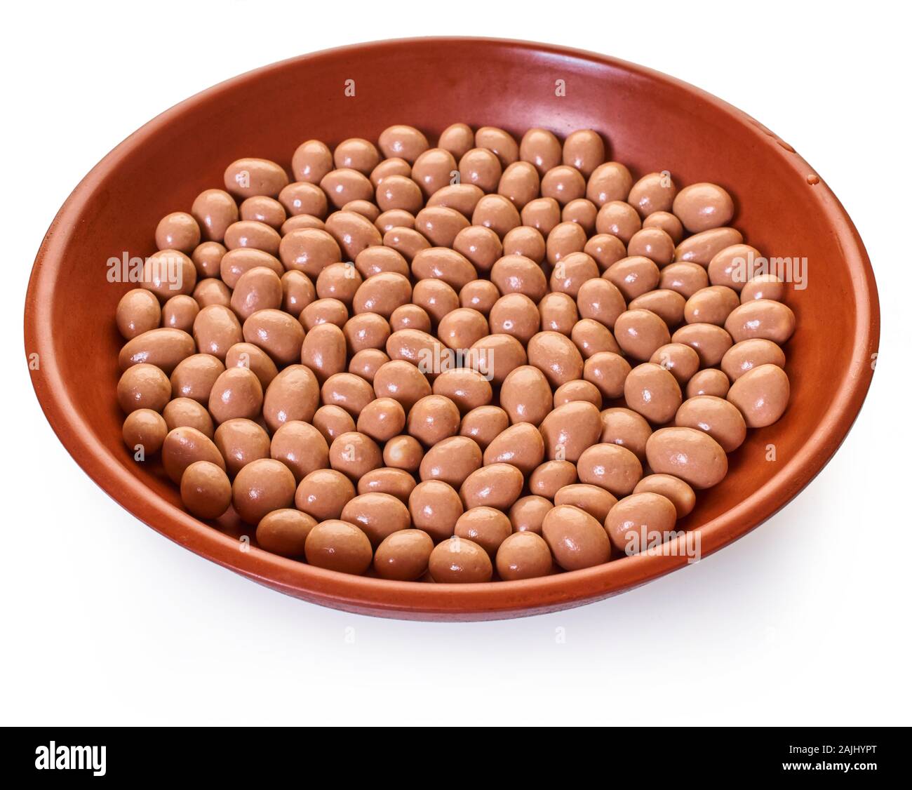 round chocolate candies in a plate on white isolated background Stock ...
