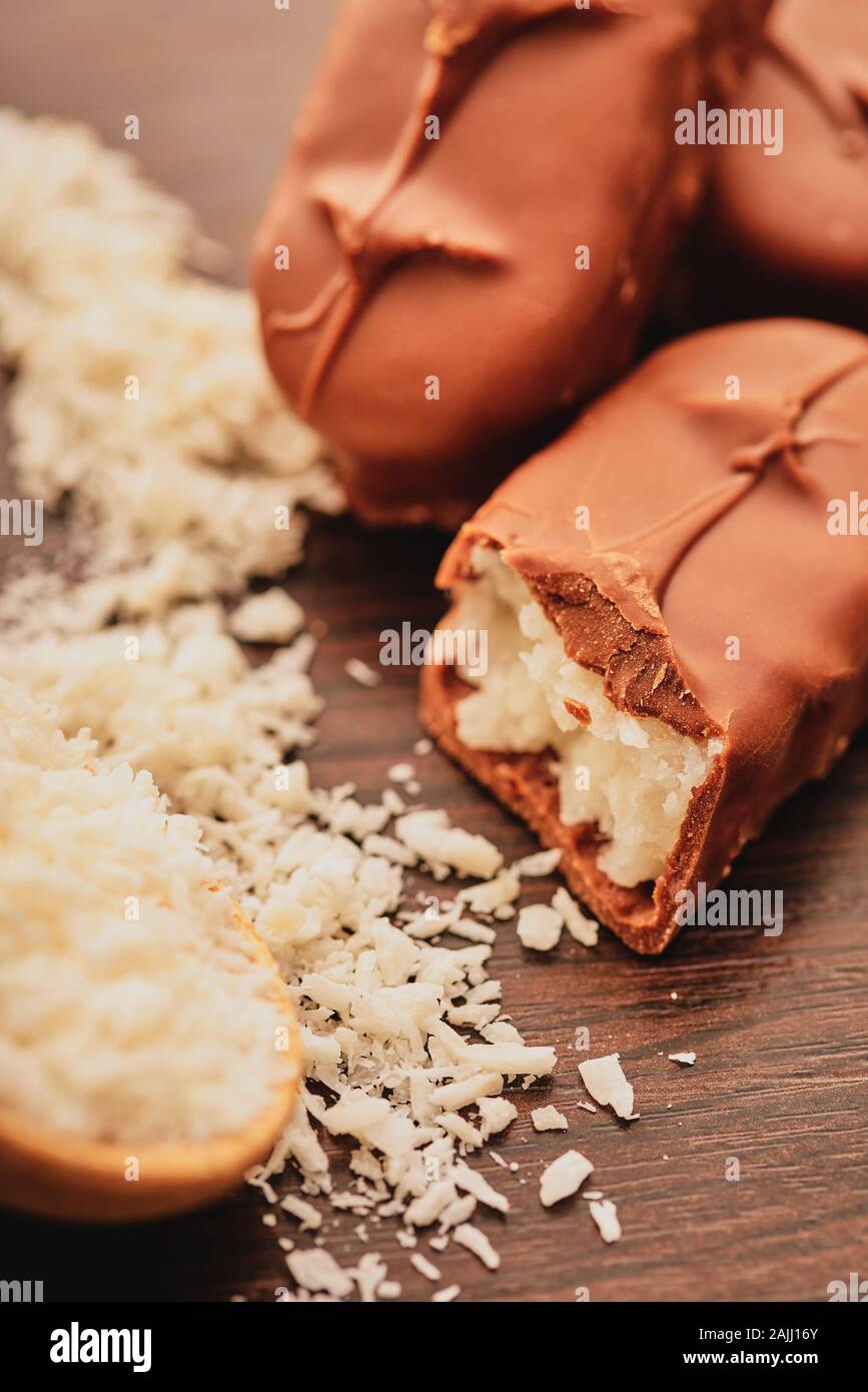chocolate bar with coconut flakes on a wooden background Stock Photo ...
