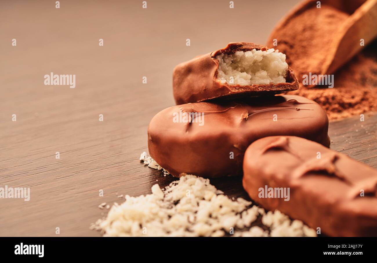 chocolate bar with coconut flakes on a wooden background Stock Photo ...