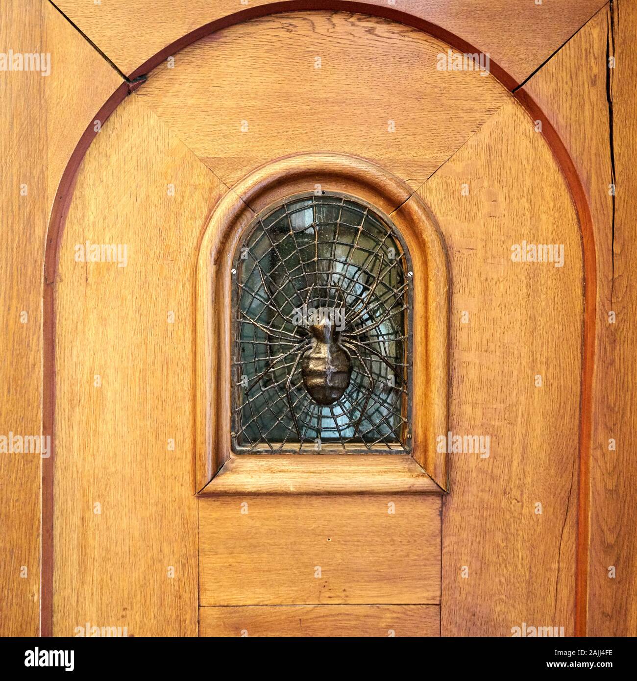 Unique iron artwork depicting a spider and web inset into an arched ...