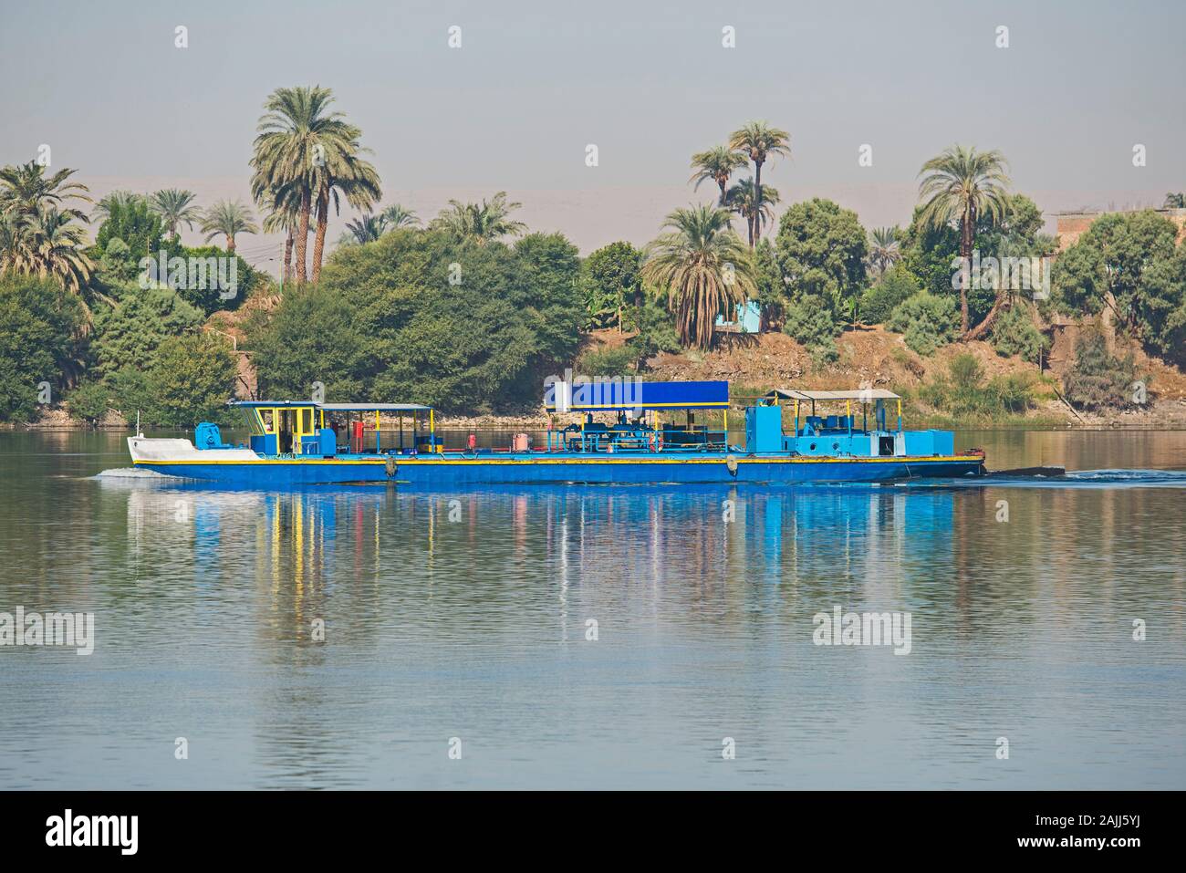 Old traditional barge boat traveling on river Nile through rural ...