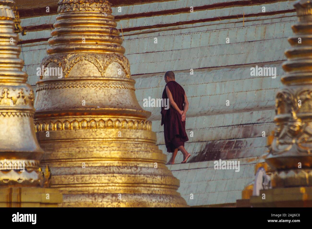 monk walking on gold temple in Myanmar Stock Photo - Alamy