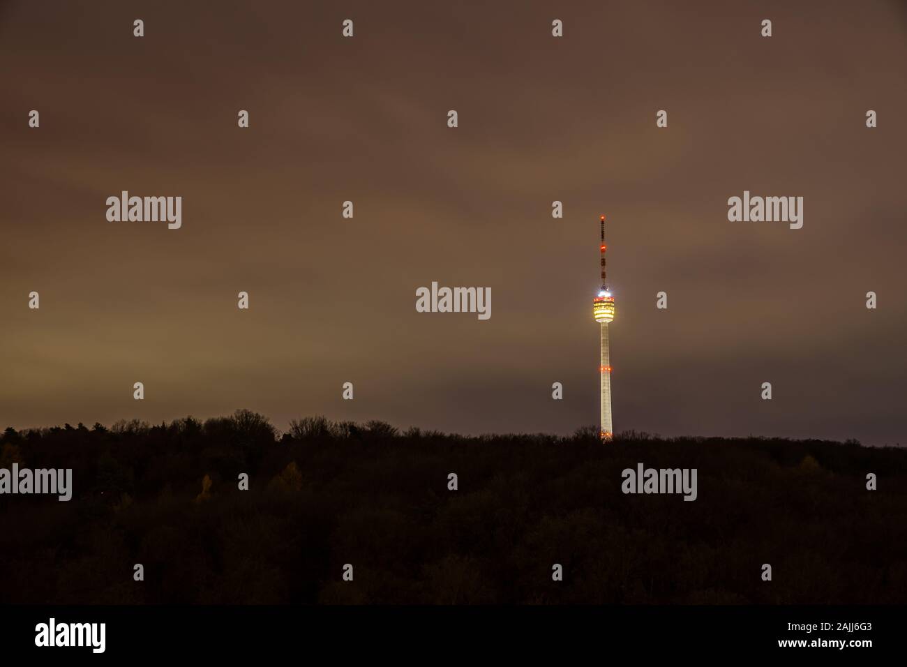 Germany, Famous illuminated tv tower building in endless forest nature ...