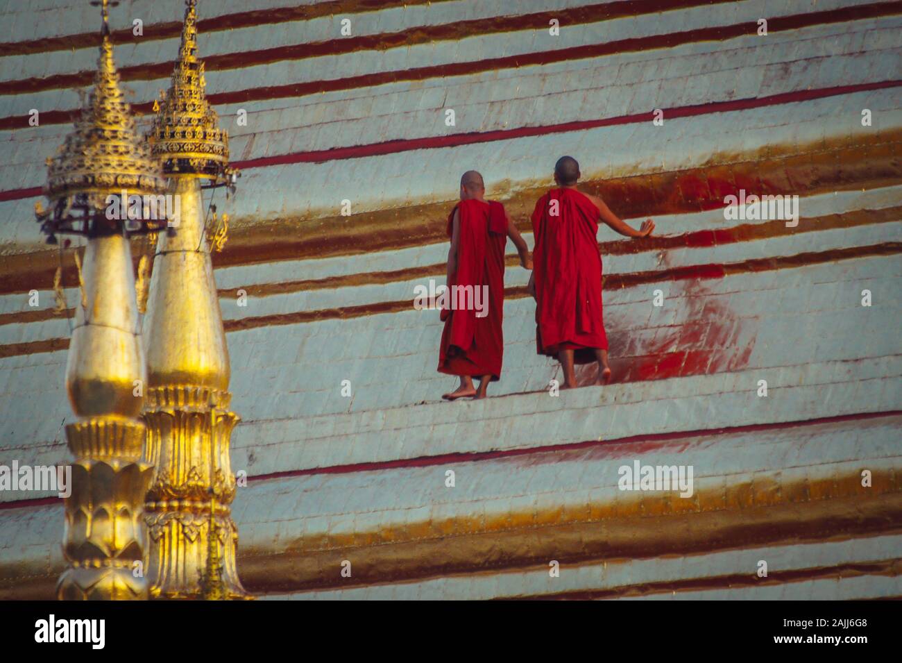 monks walking on gold temple in Myanmar Stock Photo - Alamy