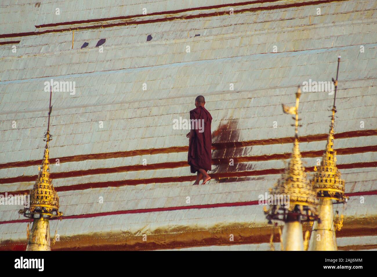 monk walking on gold temple in Myanmar Stock Photo - Alamy