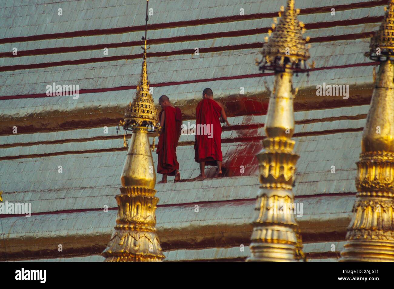 monks walking on gold temple in Myanmar Stock Photo - Alamy