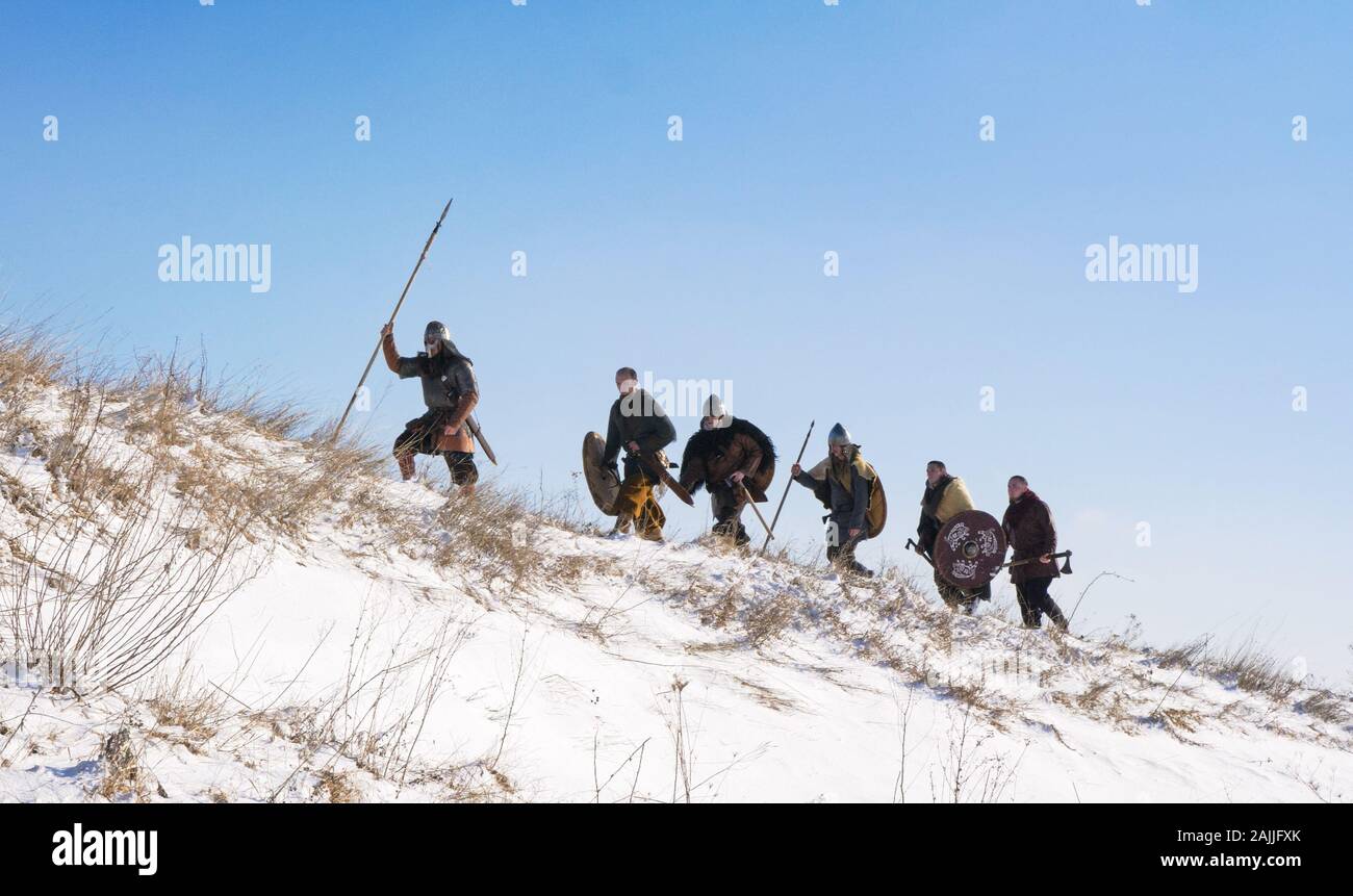 Group of Vikings with shields and swords going forward on the winter ...