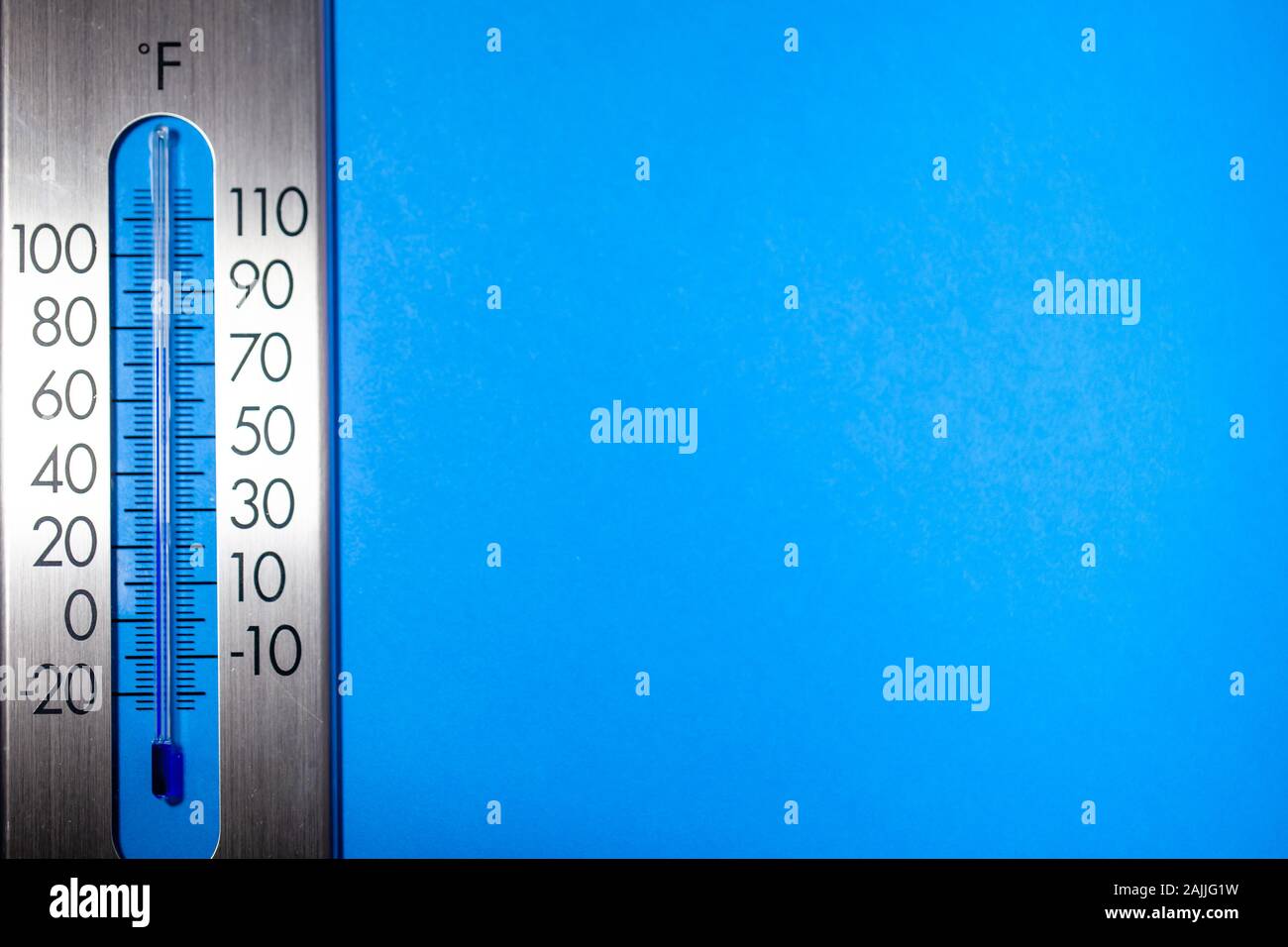 Silver thermometer with blue background for copy space Stock Photo - Alamy