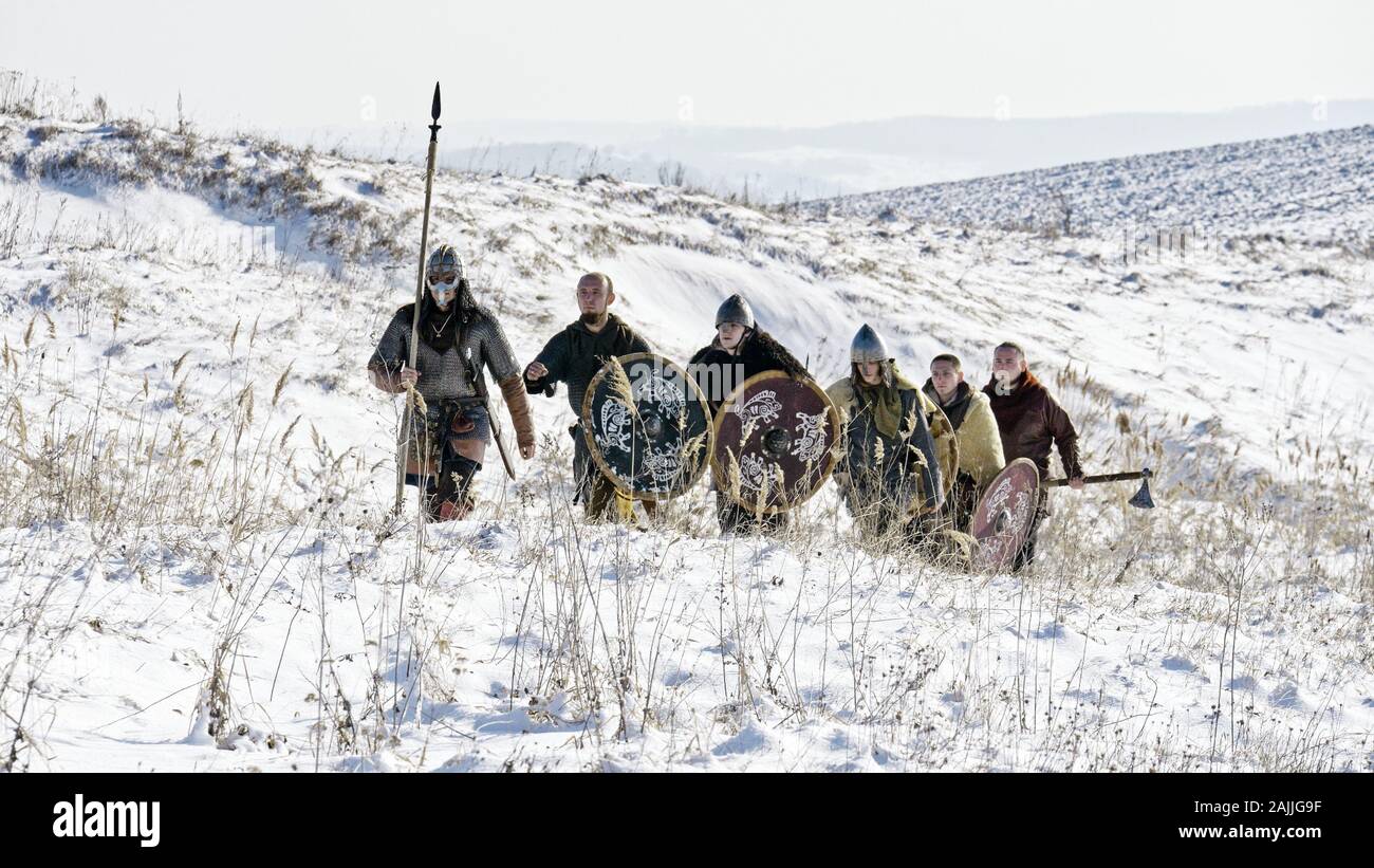 Group of Vikings with shields and swords going forward on the winter ...