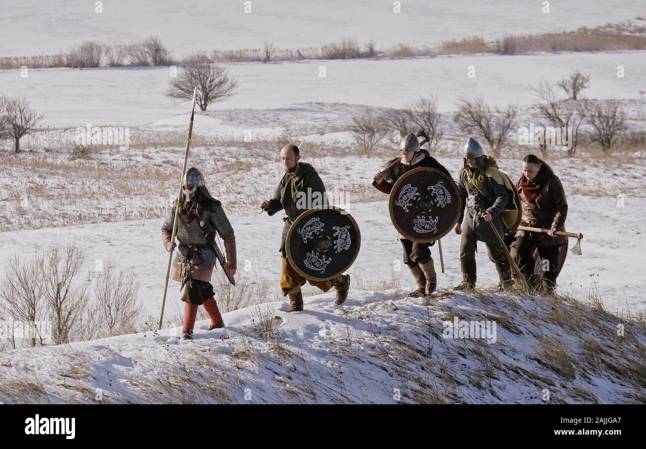 Group of Vikings with shields and swords going forward on the winter ...
