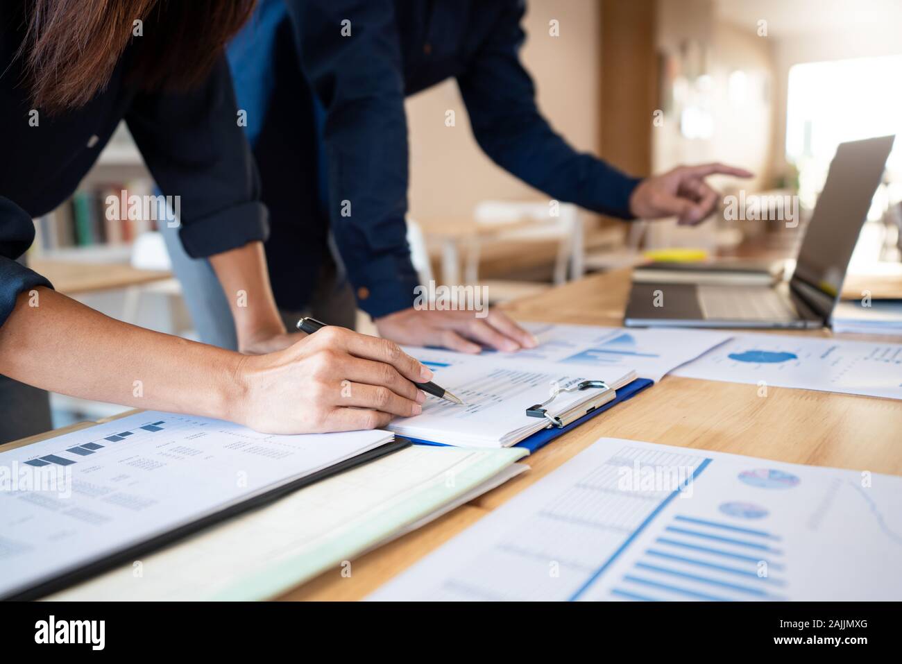 Business People Meeting to analyse and discuss and brainstorming the financial report chart data ...