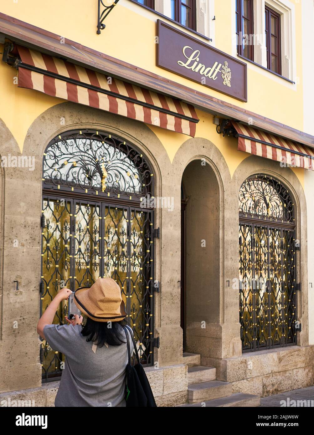 Tourist takes photo with cell phone of the famous Lindt Chocolate store ...
