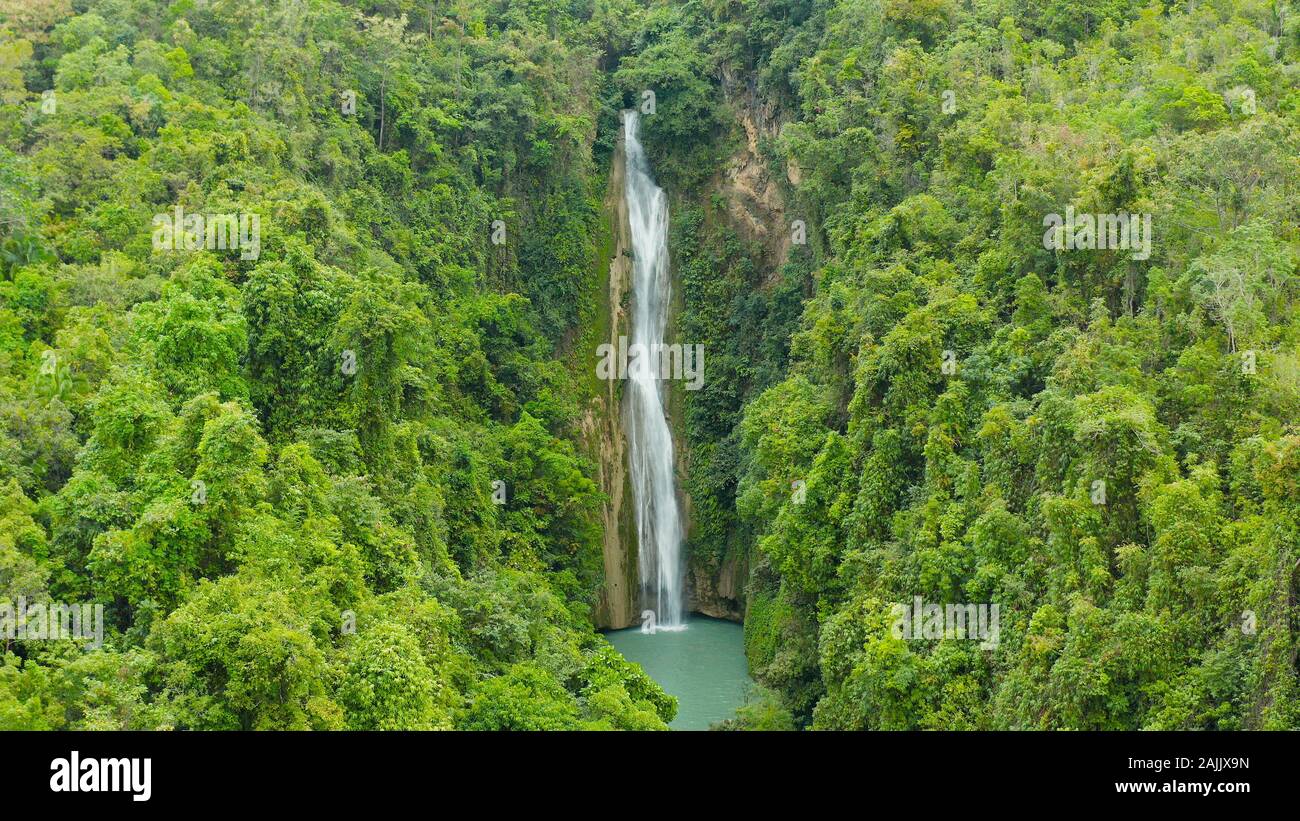 Aerial view of Mantayupan waterfalls in a mountain gorge in the tropical jungle, Philippines ...