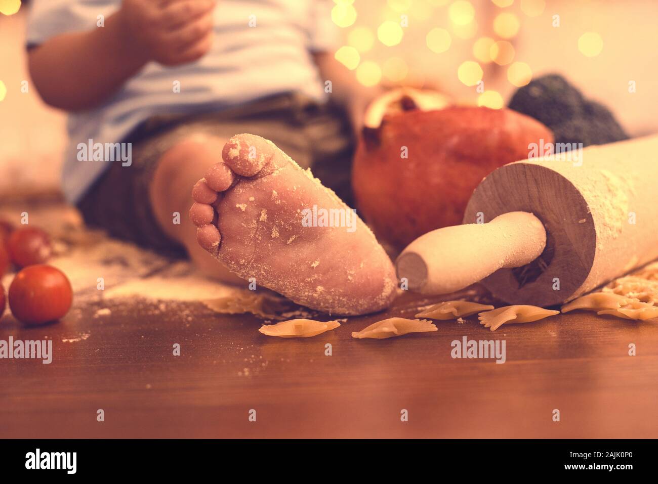 The foot of a young child in the kitchen. The concept of baby food ...