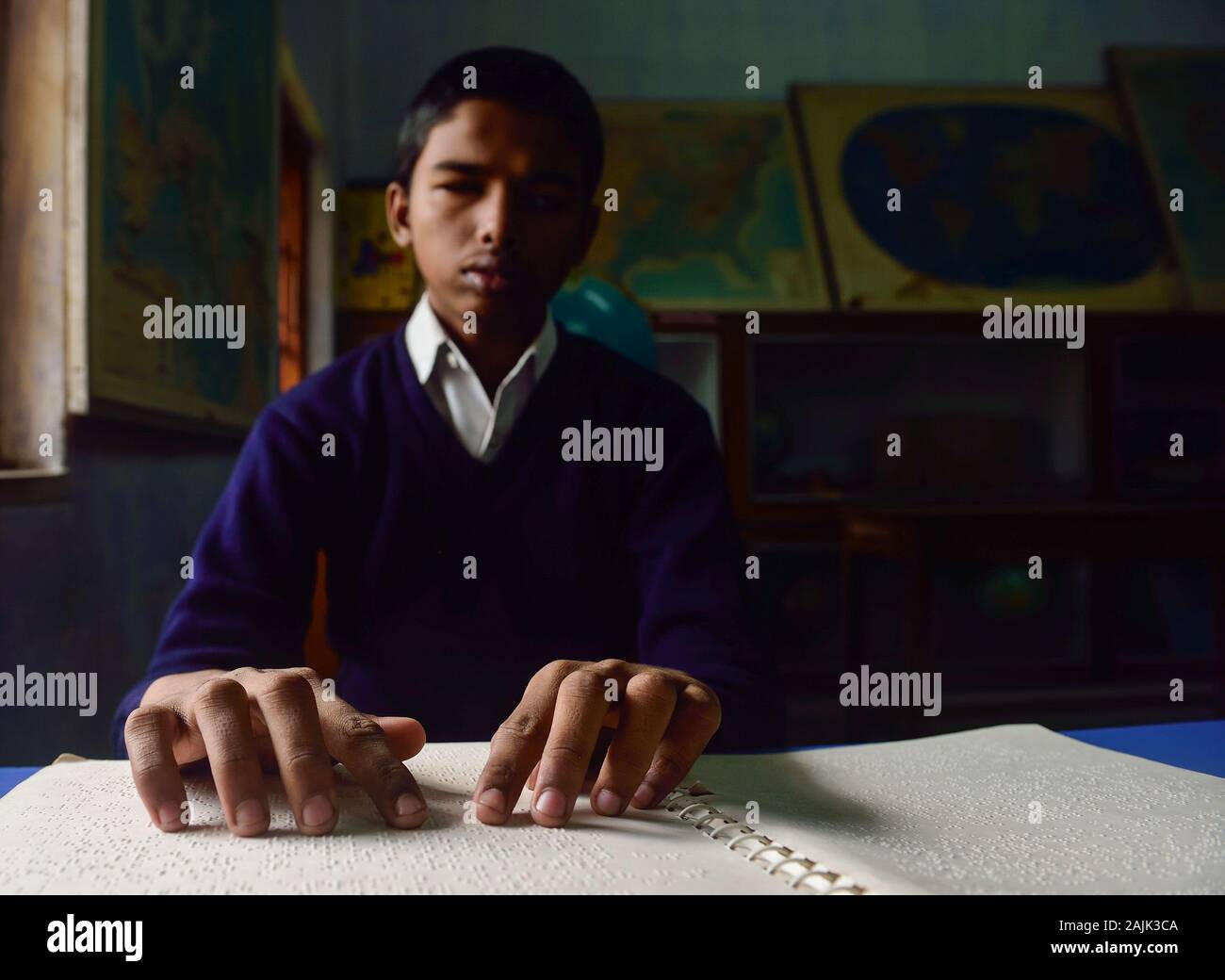 Visually impaired student reads with the help of braille fonts on World ...