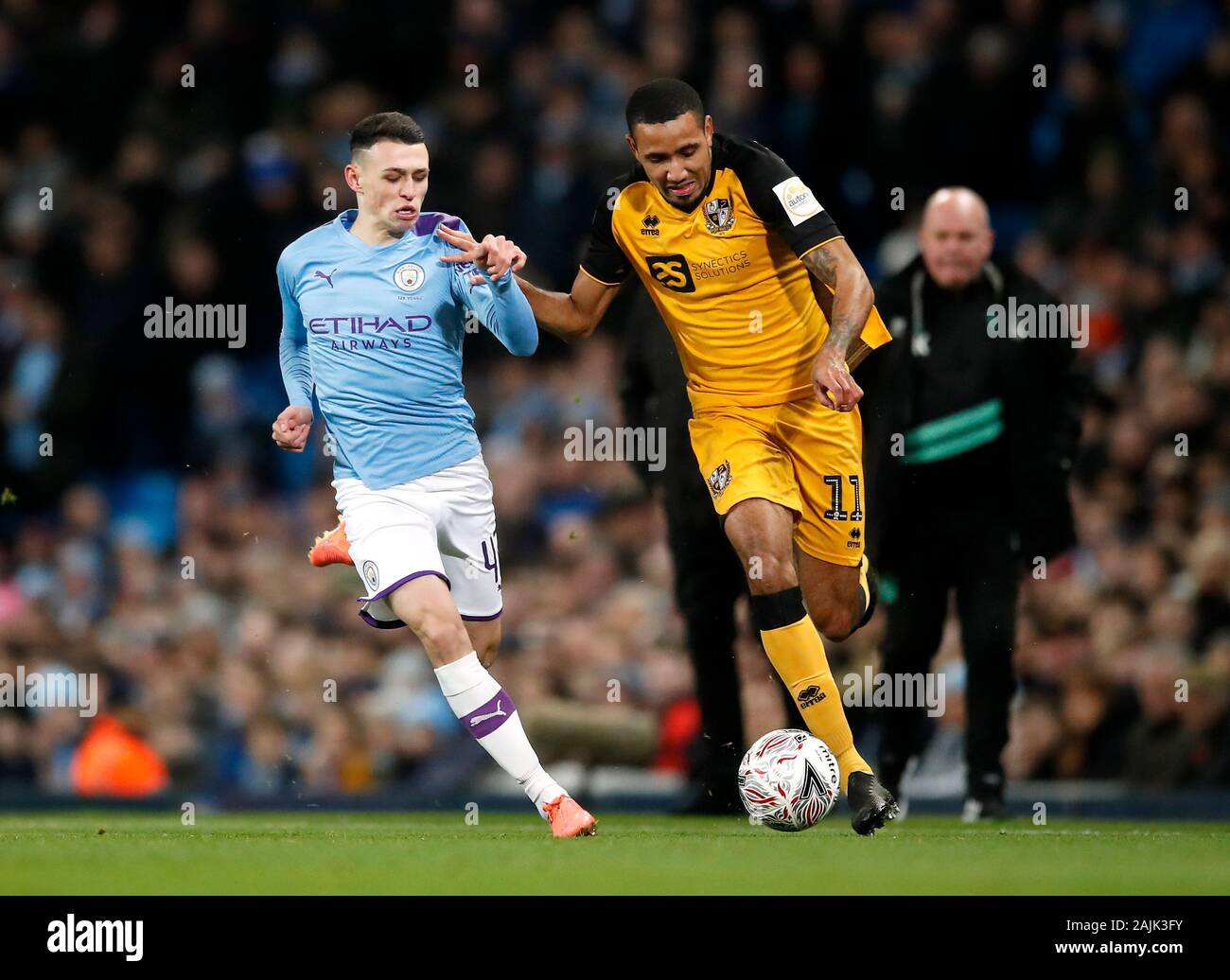 Manchester City's Phil Foden (left) and Port Vale's Cristian Montano ...