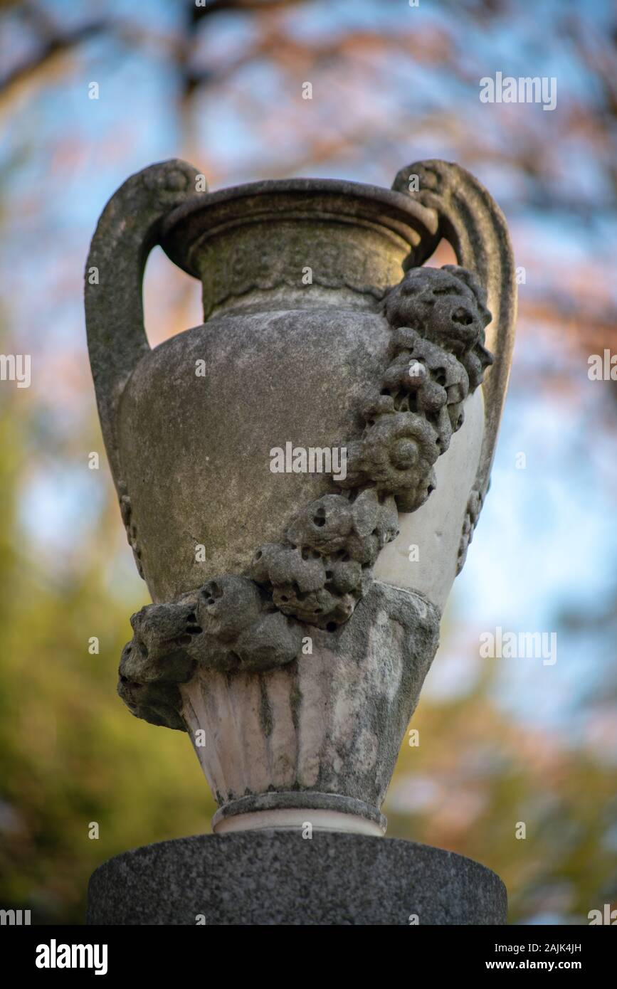 Garden decoration - ancient stone vase with a flower garland on a ...