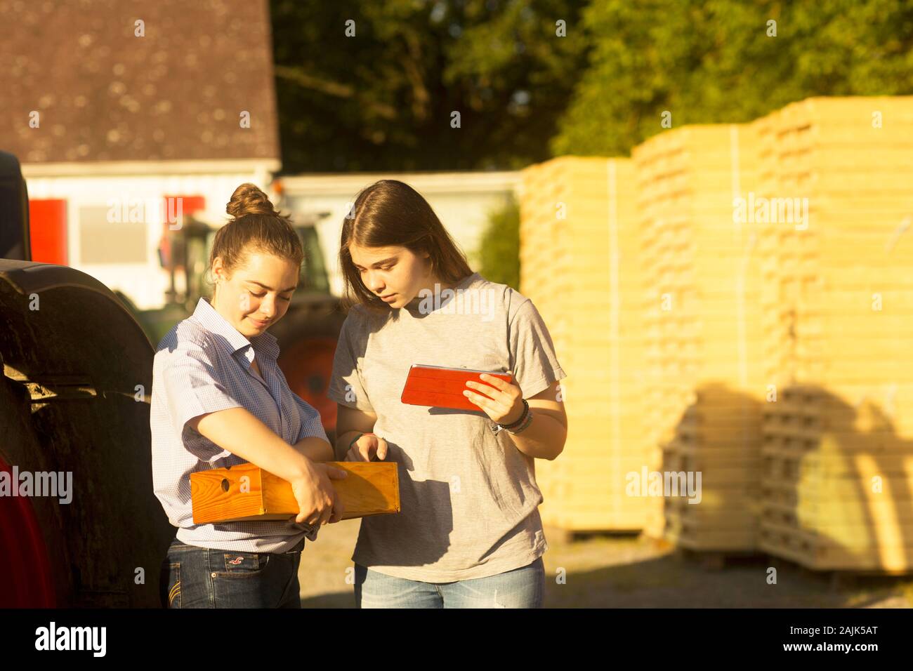 Farmer women checking box in a farm Stock Photo - Alamy