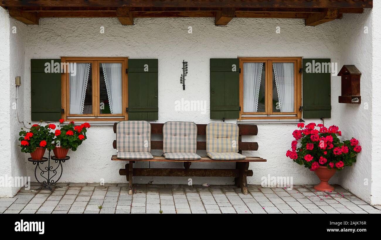 Cute little patio, bench and flowers in a typical Bavarian home in the ...