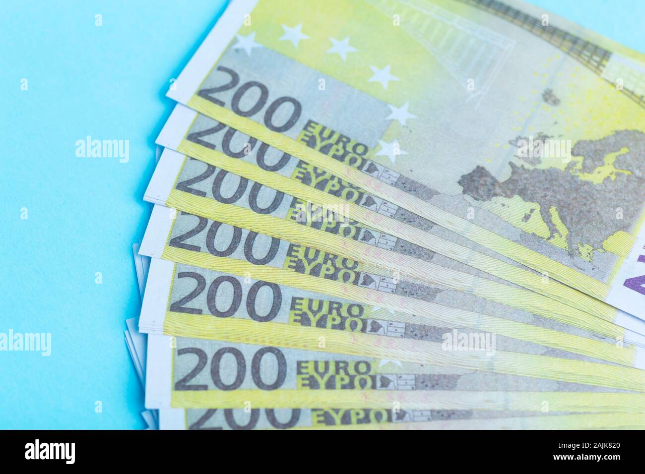 Money and income concept. Euro cash banknotes on a blue background ...