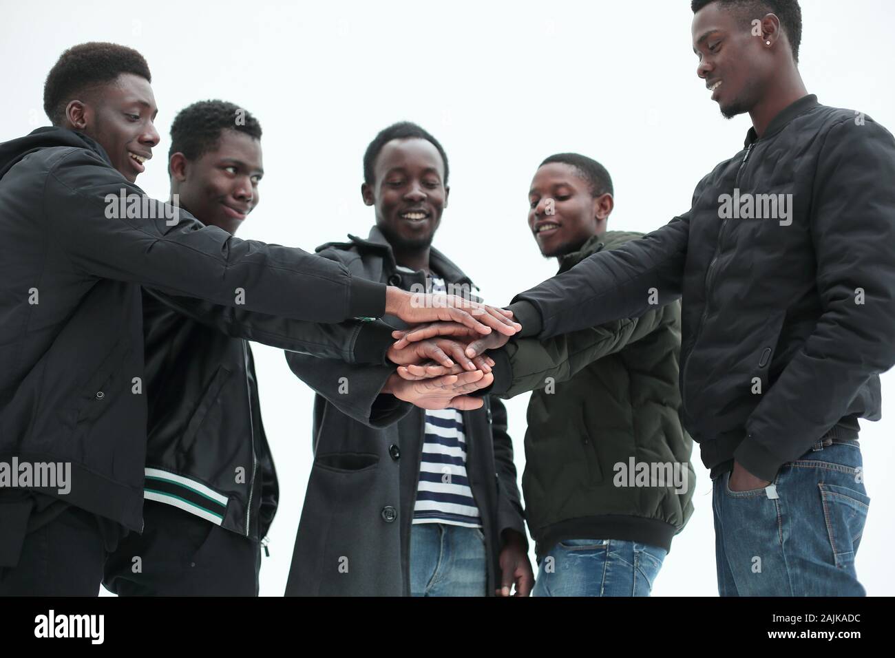 close up. group of guys putting their hands together Stock Photo - Alamy
