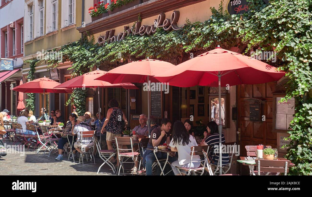 Crowd of people dining at a sidewalk cafe and restaurant in the oldest ...