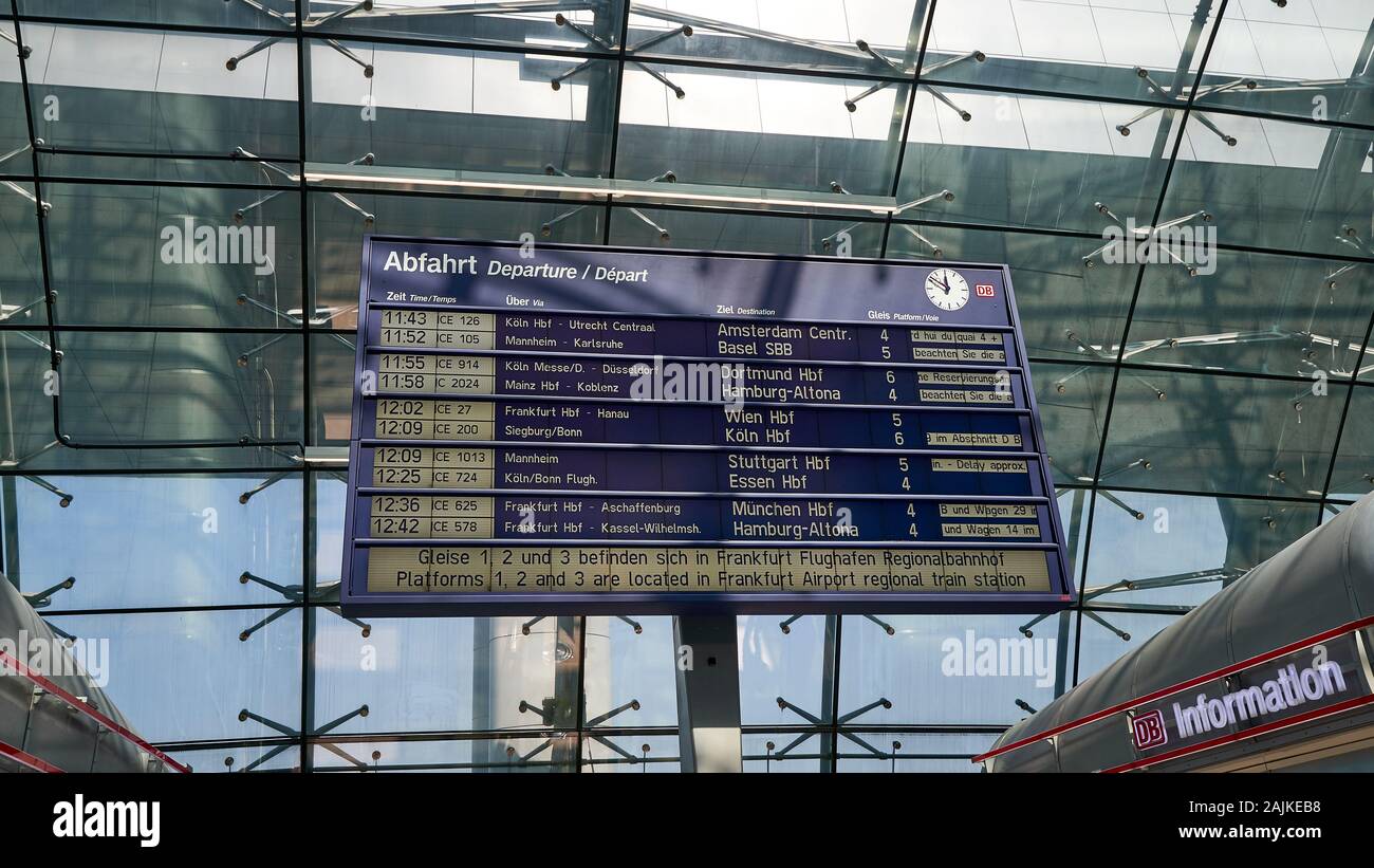 Departure board showing train schedules at the busy train station ...