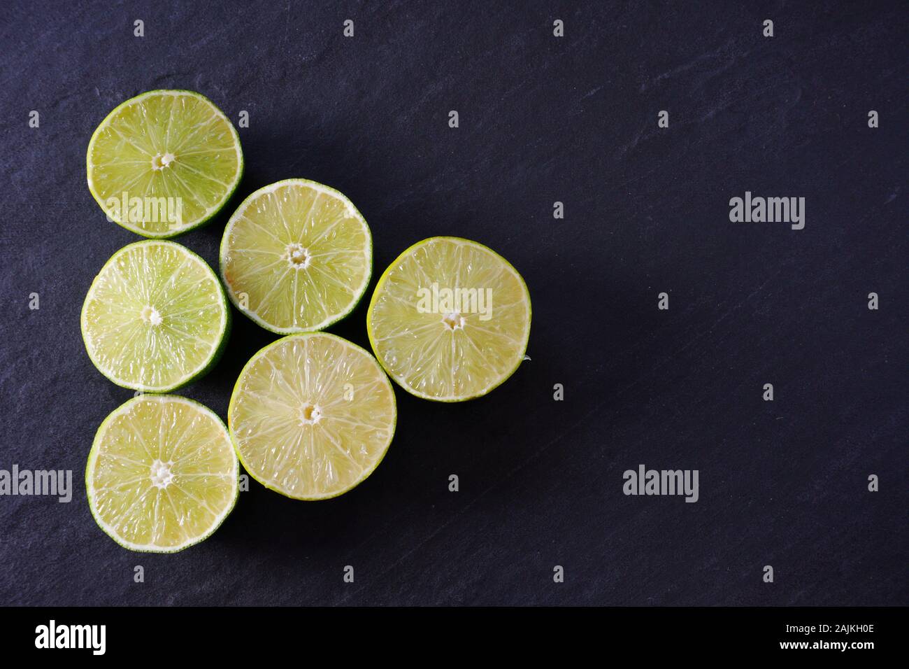 A pyramid of lime halves pointing to the right where there is black ...