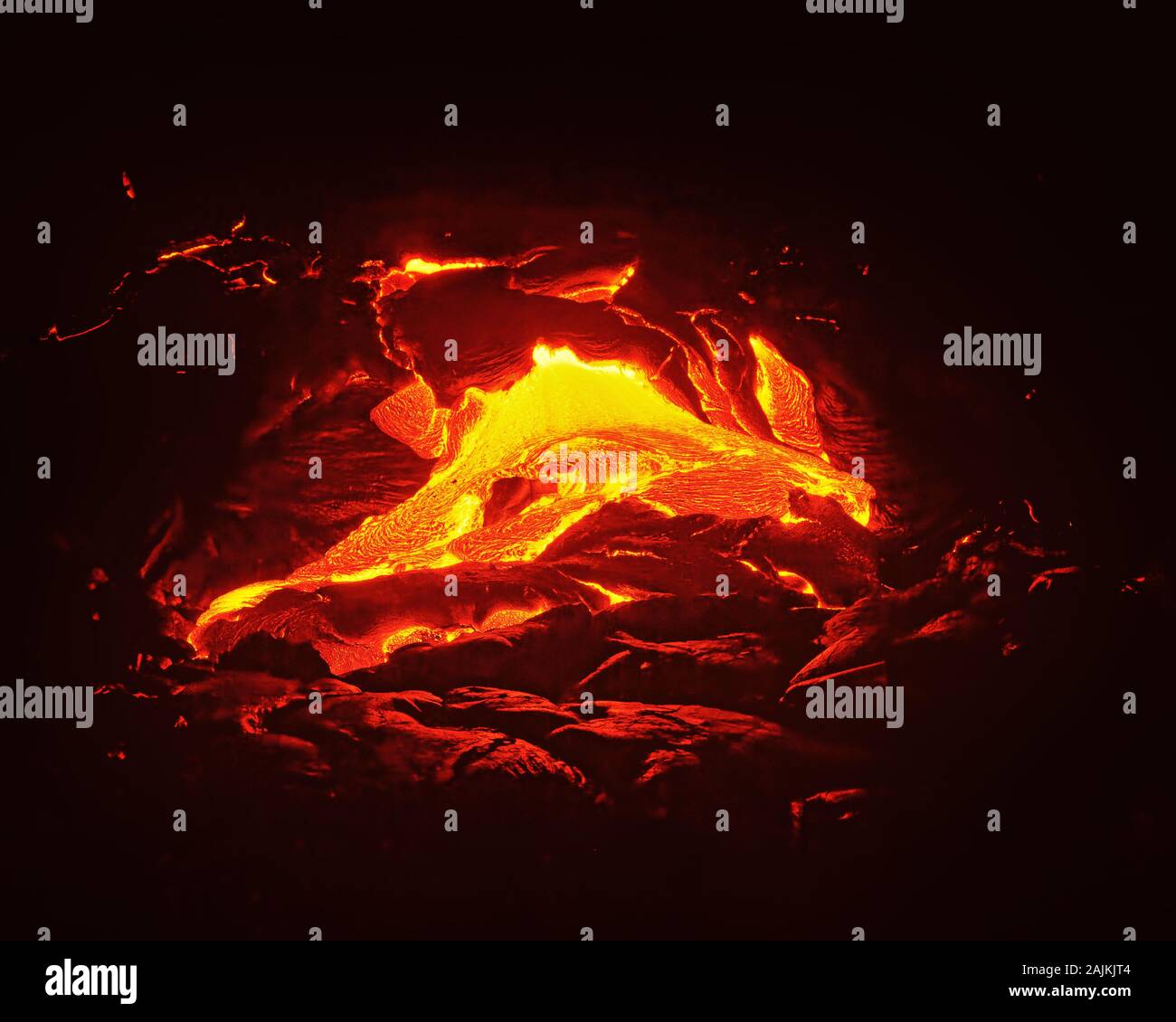Scenic view of a part of a lava flow in the dark, the hot lava shows up ...