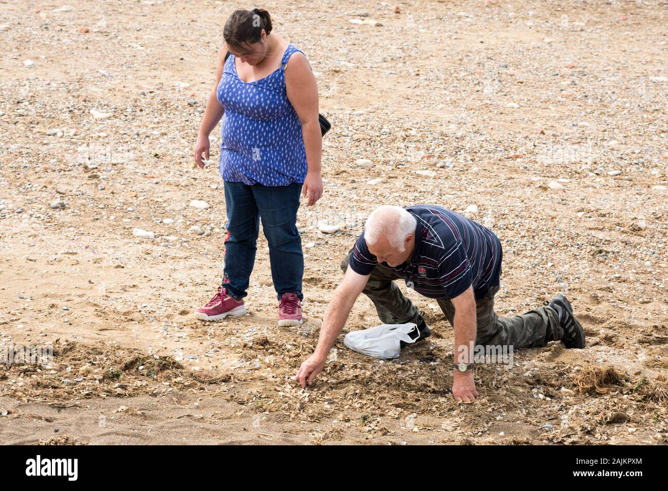 Couple digging on beach sand hi-res stock photography and images - Alamy