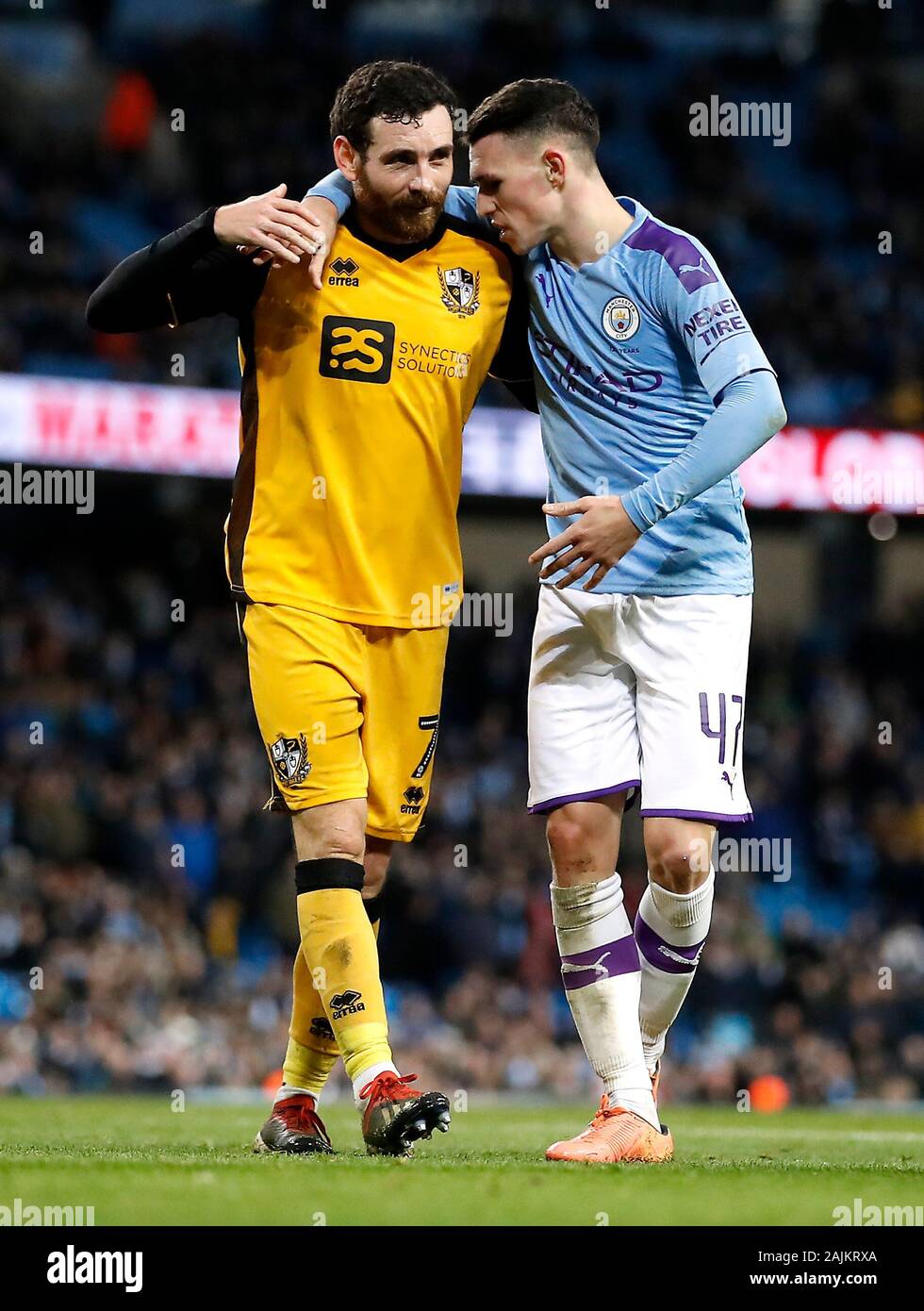 Port Vale's David Worrall (left) and Manchester City's Phil Foden ...