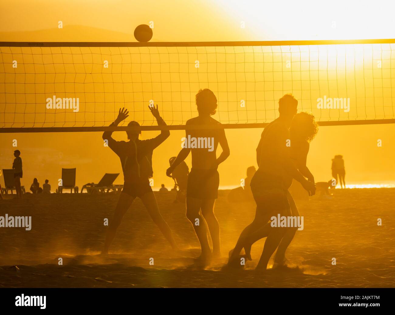 Beach volleyball at sunset Stock Photo - Alamy