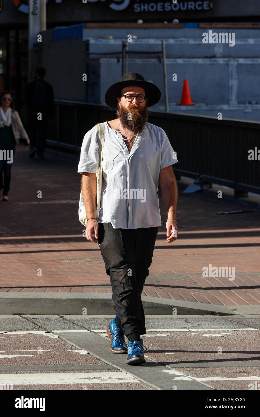 Bearded man with a wide-brimmed hat crossing the street Stock Photo - Alamy