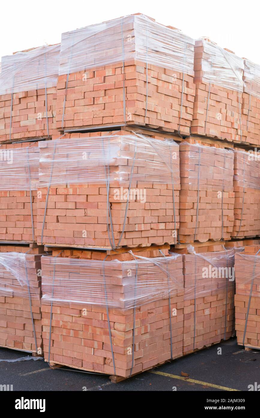 Several pallets with concrete brick stacked on top of each other in ...