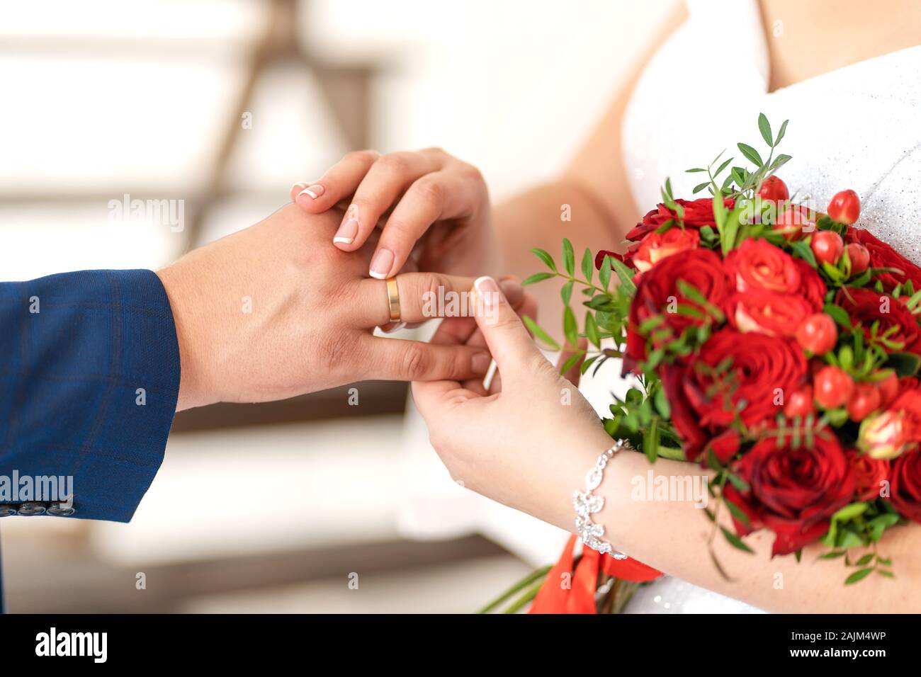 The bride puts a wedding ring on the finger of the groom. Wedding ...