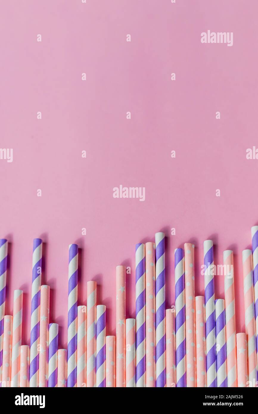 Striped drink straws of different colors in row isolated on yellow ...