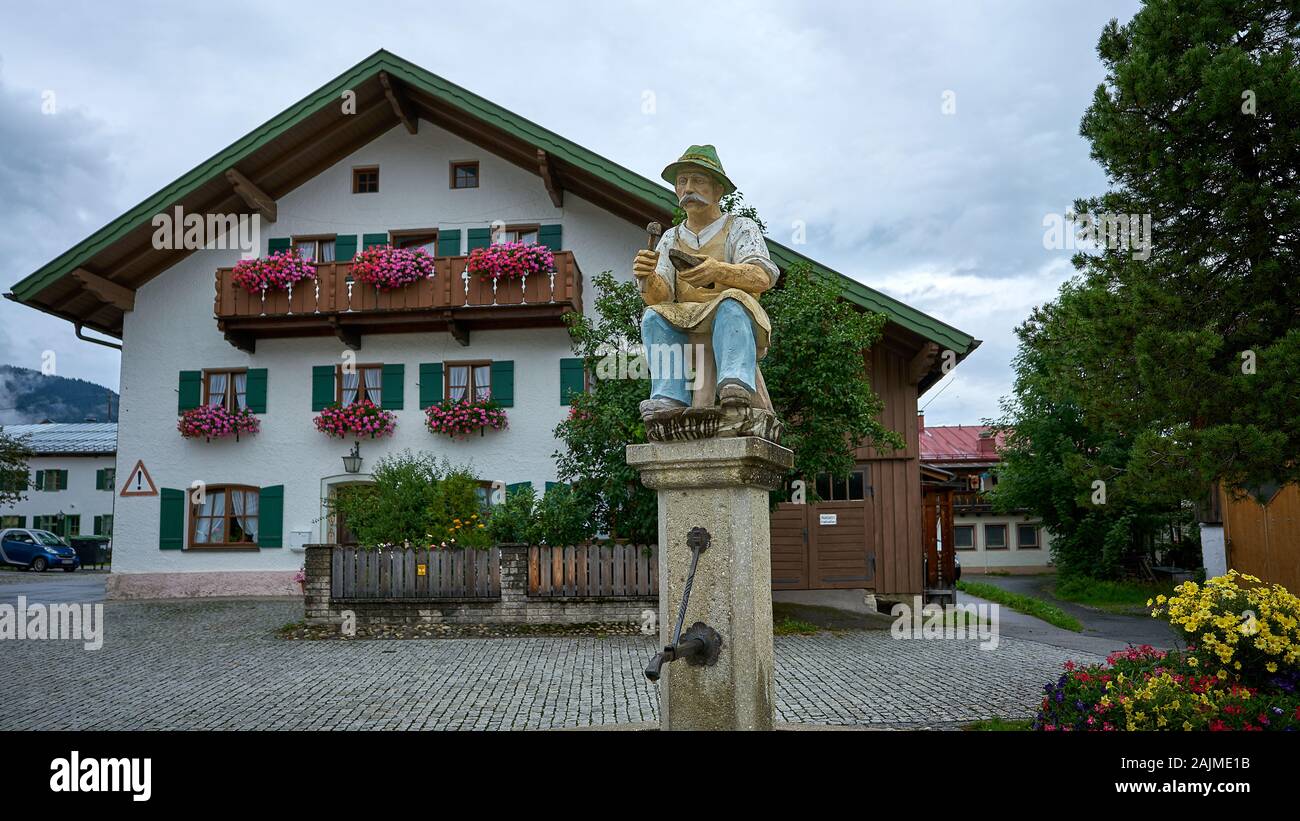 Typical Bavarian home with bigger than life size wood carving depicting ...