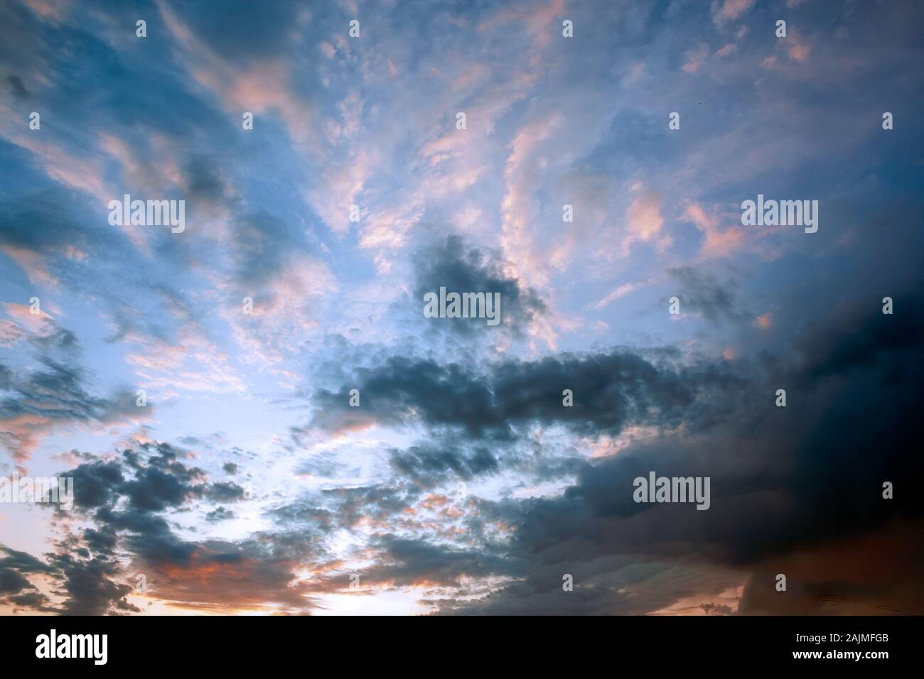 Multi colored clouds at sunset. The clouds lit by the setting sun Stock ...