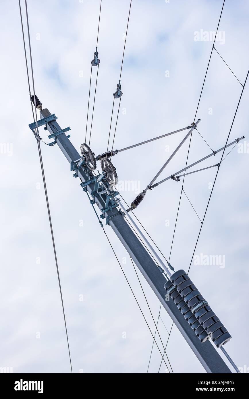 Railway electrification system details. Electric power overhead line, steel pylon with concrete ...