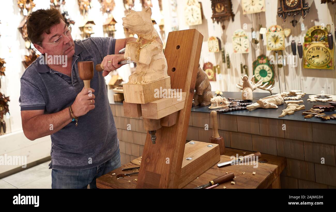 Woodworker demonstrates his craft while working on making a bear ...