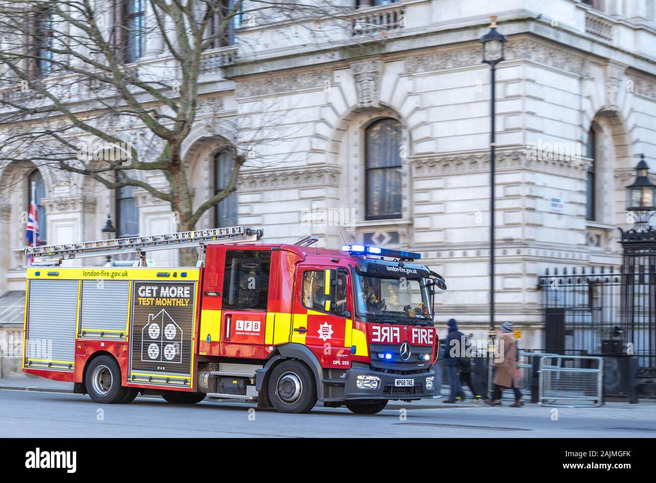 London Fire Brigade fire engine passes Downing Street, Westminster ...