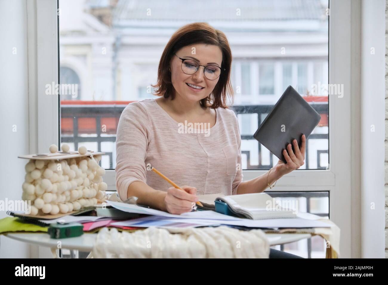 Female decorator working with samples of materials Stock Photo - Alamy