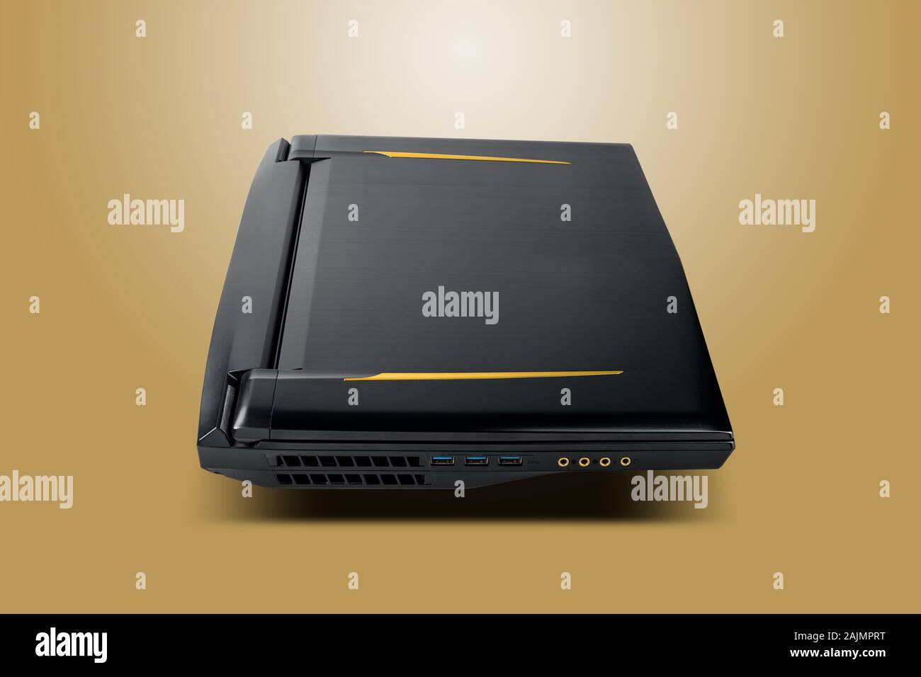 Side view of gaming laptop on golden yellow background. Laptop designed ...