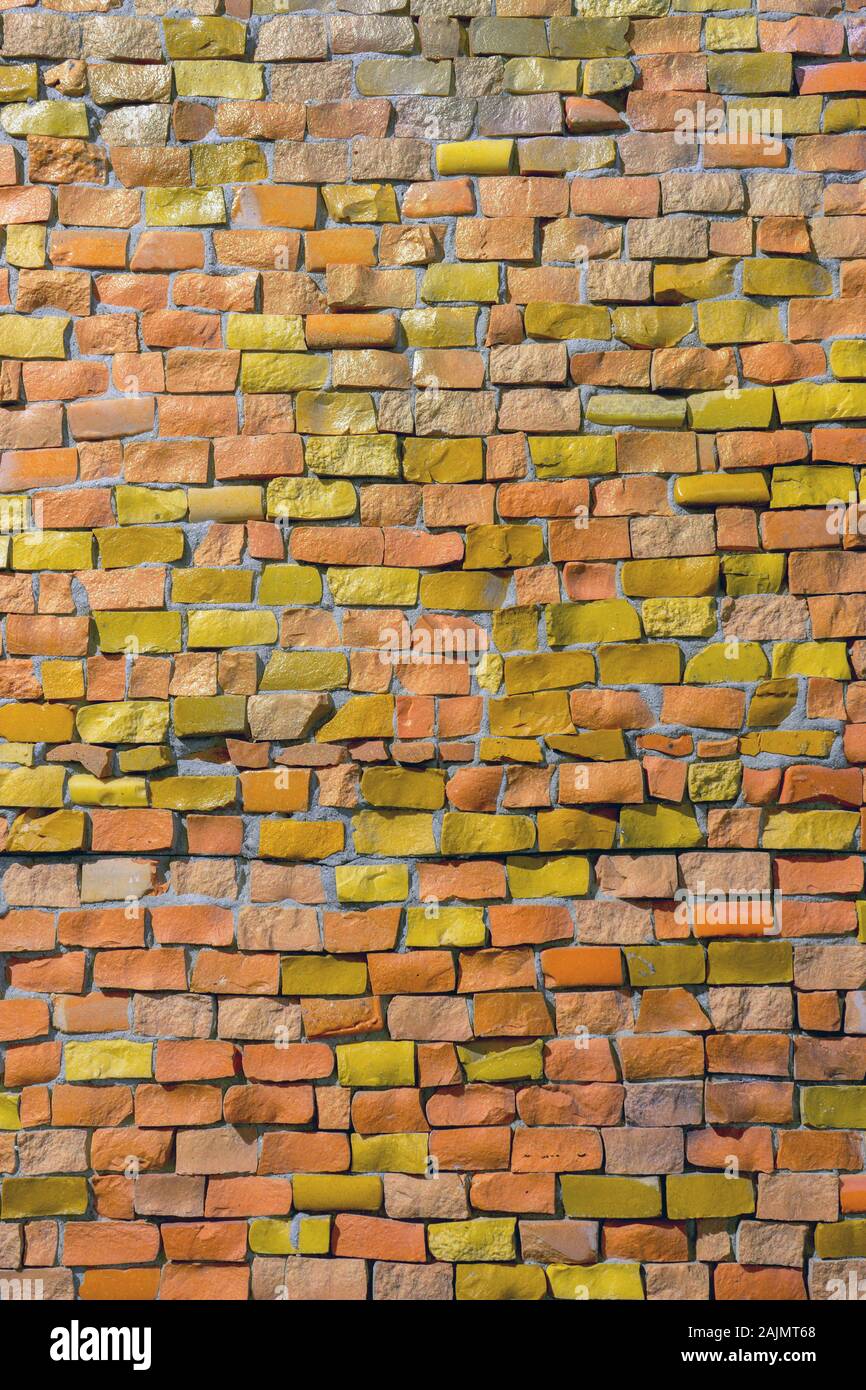 surface of old crumbling abstract decorative mosaic with faded orange ...